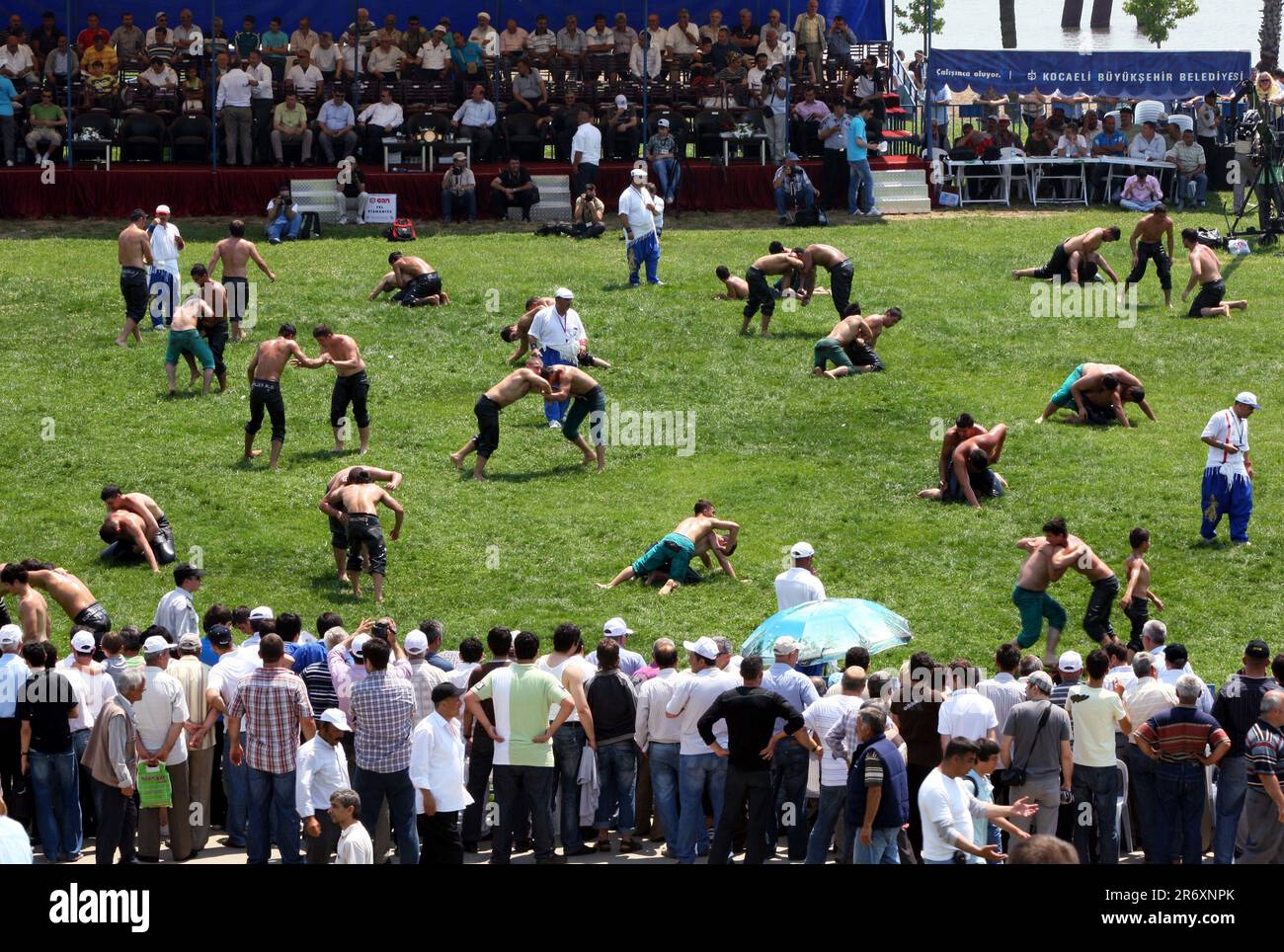 A large crowd of spectators surround the arena as competition takes ...