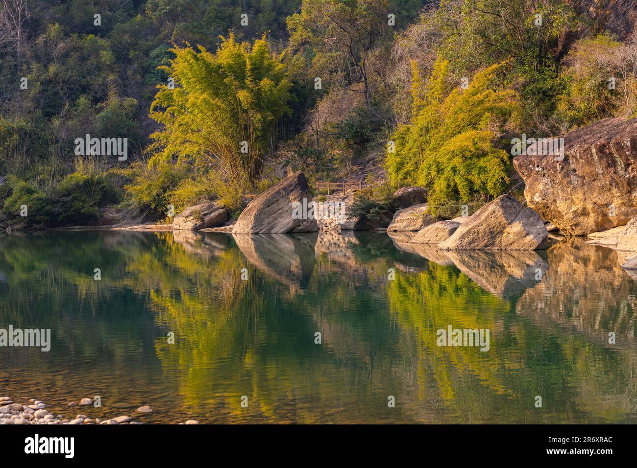 The emerald green water of the Nine Bend River or Jiuxi river through ...