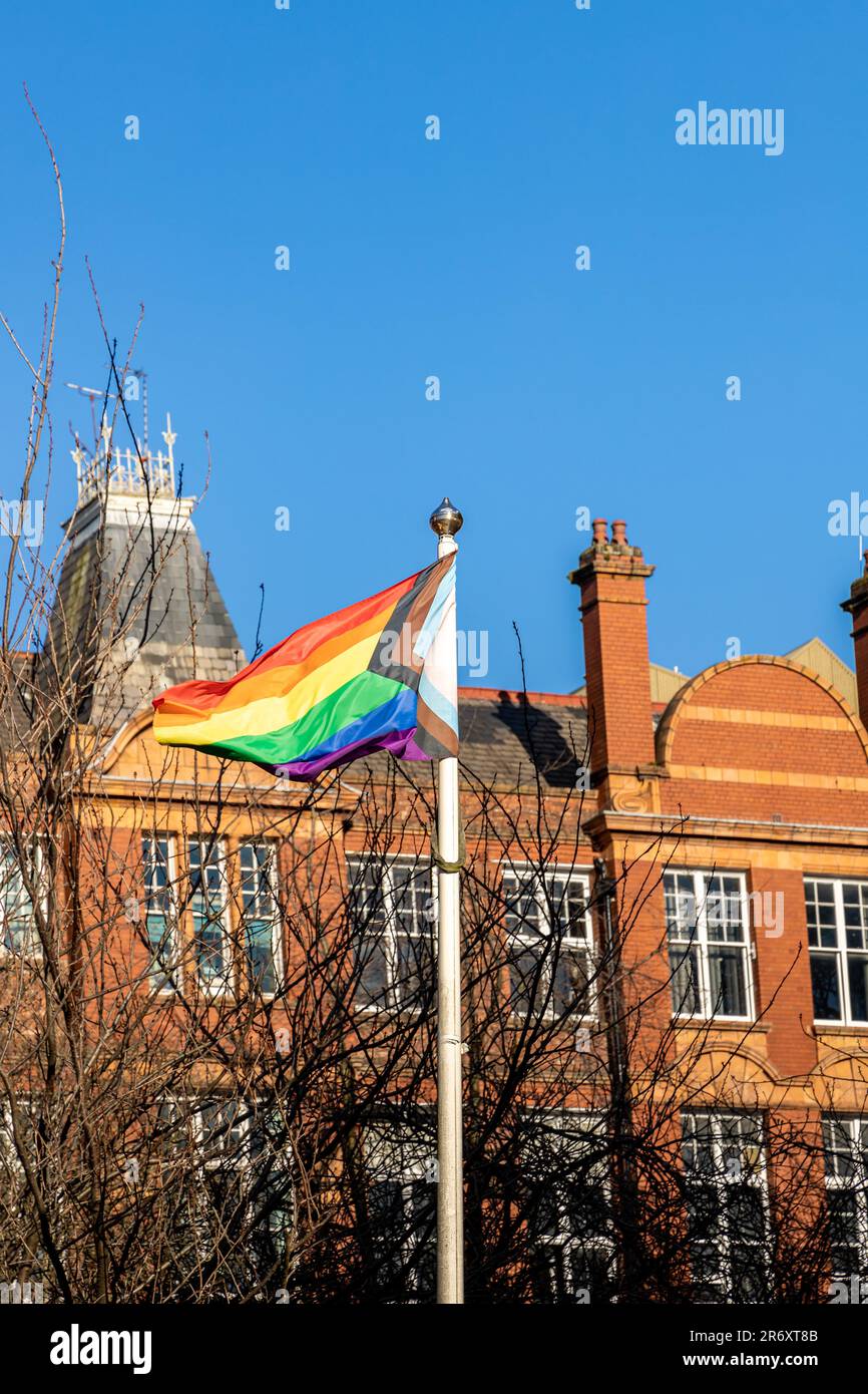 A vibrant rainbow lgbt flag billowing in the wind atop a majestic ...
