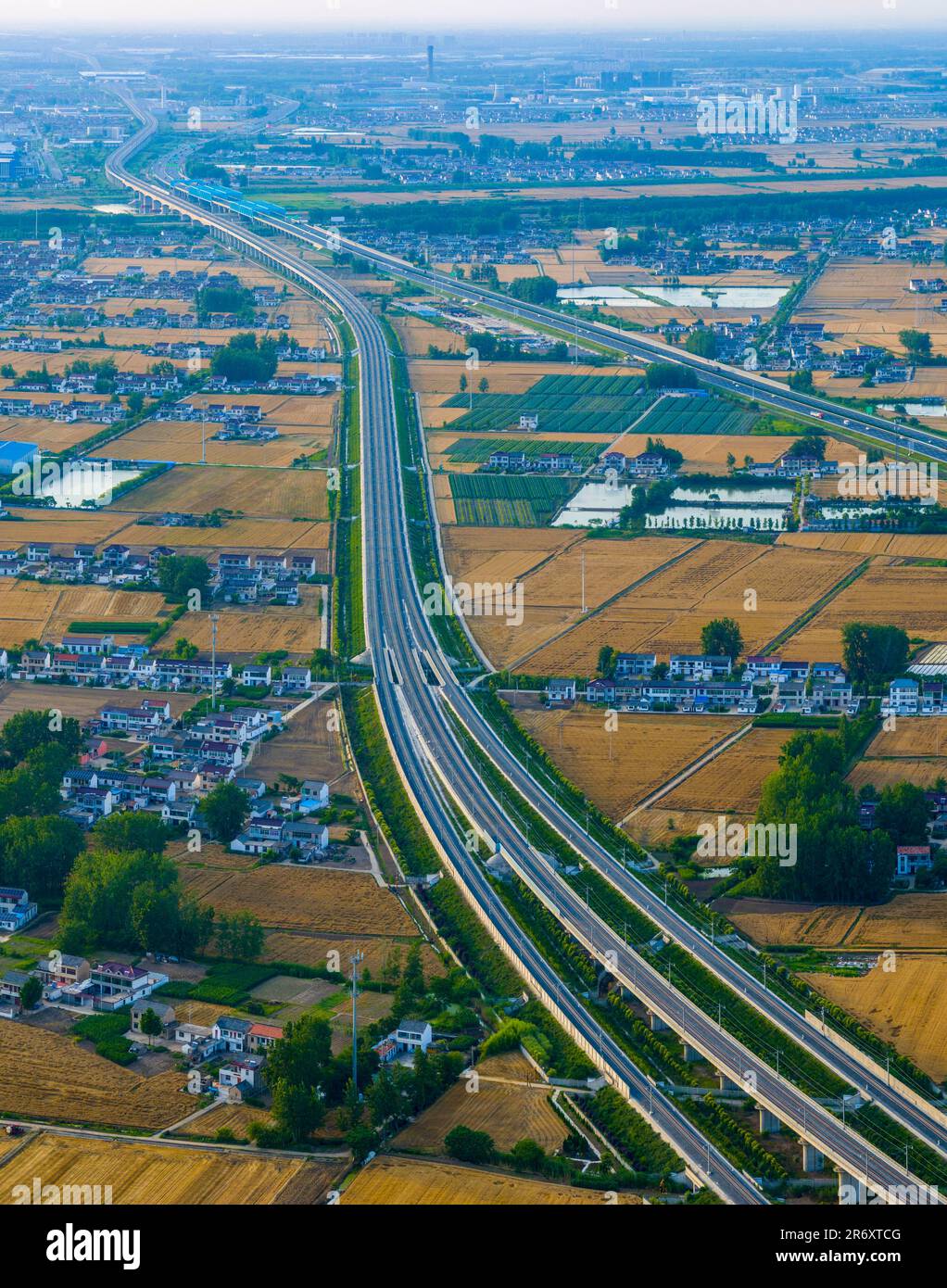 HUAI'AN, CHINA - JUNE 11, 2023 - High-speed trains pass through fields ...