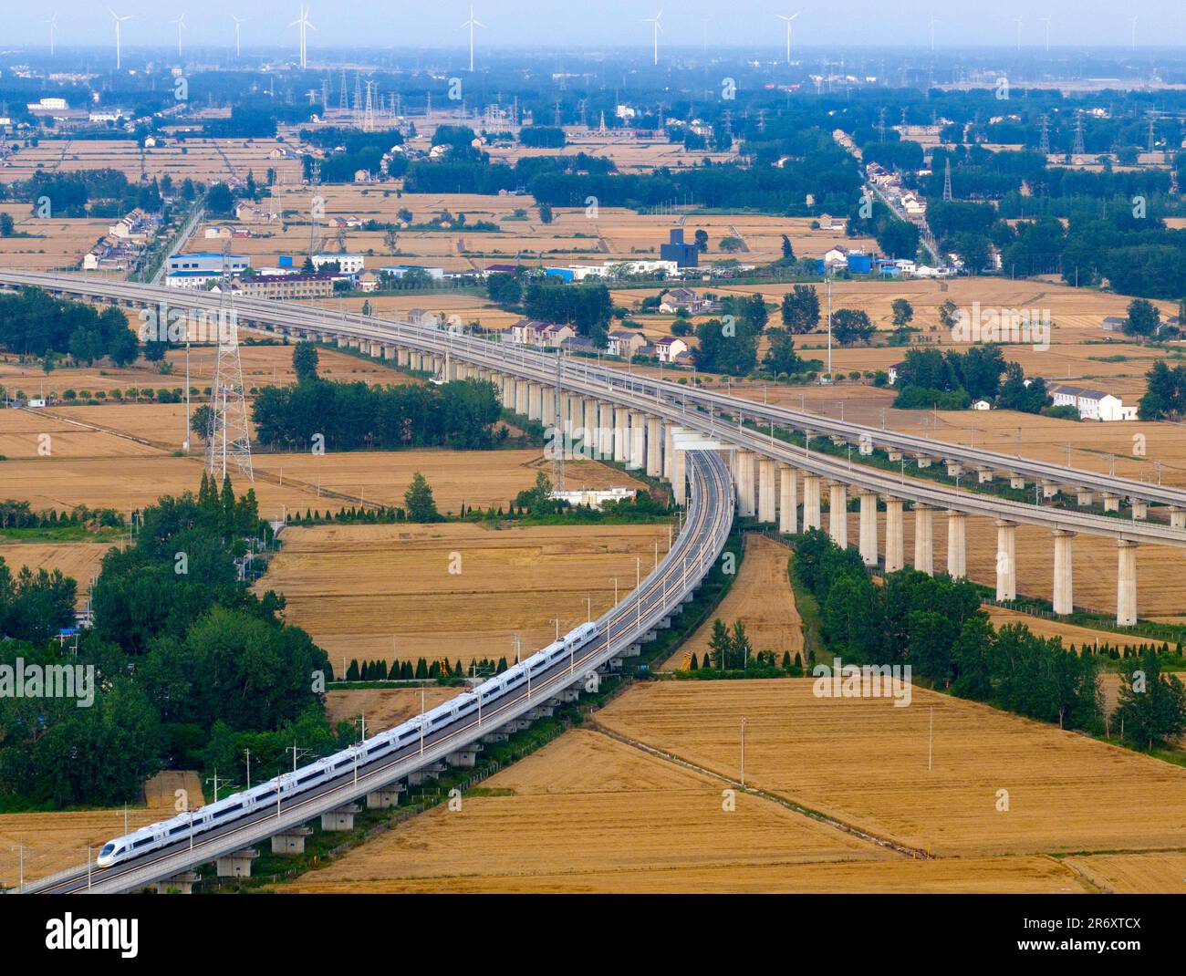 HUAI'AN, CHINA - JUNE 11, 2023 - High-speed trains pass through fields ...