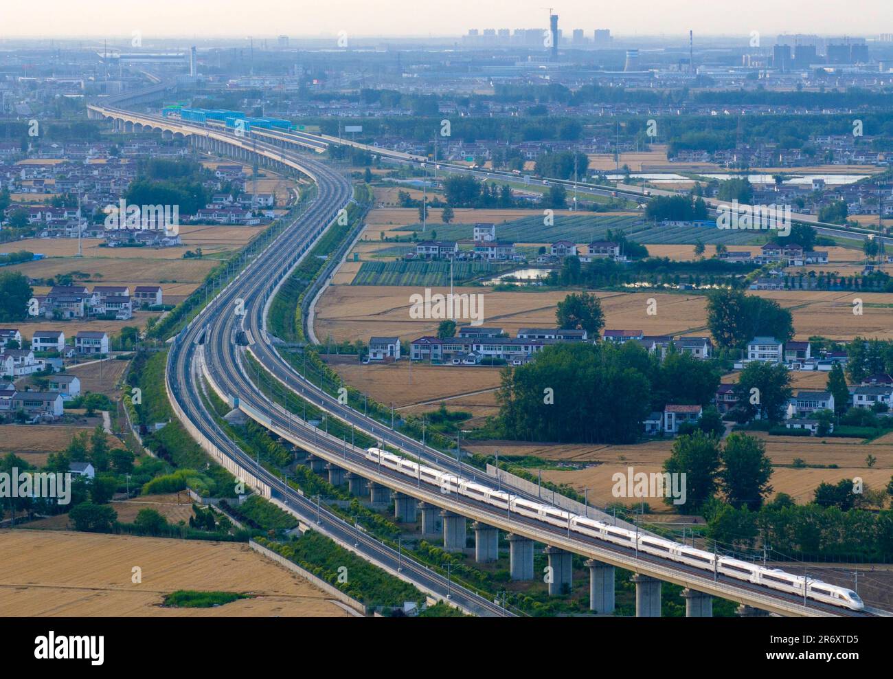 HUAI'AN, CHINA - JUNE 11, 2023 - High-speed trains pass through fields ...