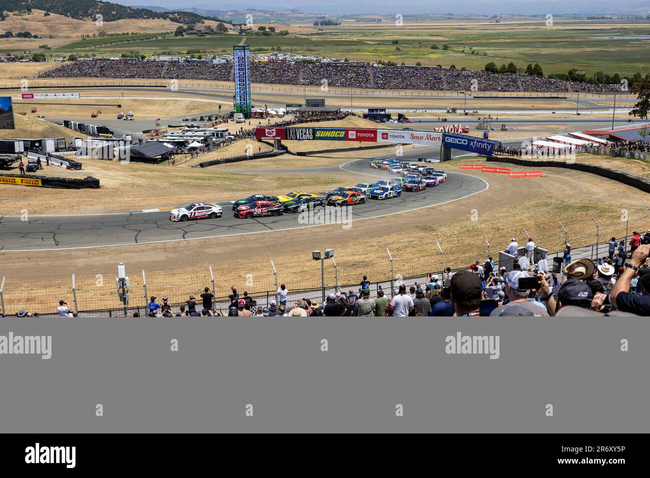 SONOMA, CA - JUNE 11: The field rounds turn 2 in view of the grandstand ...