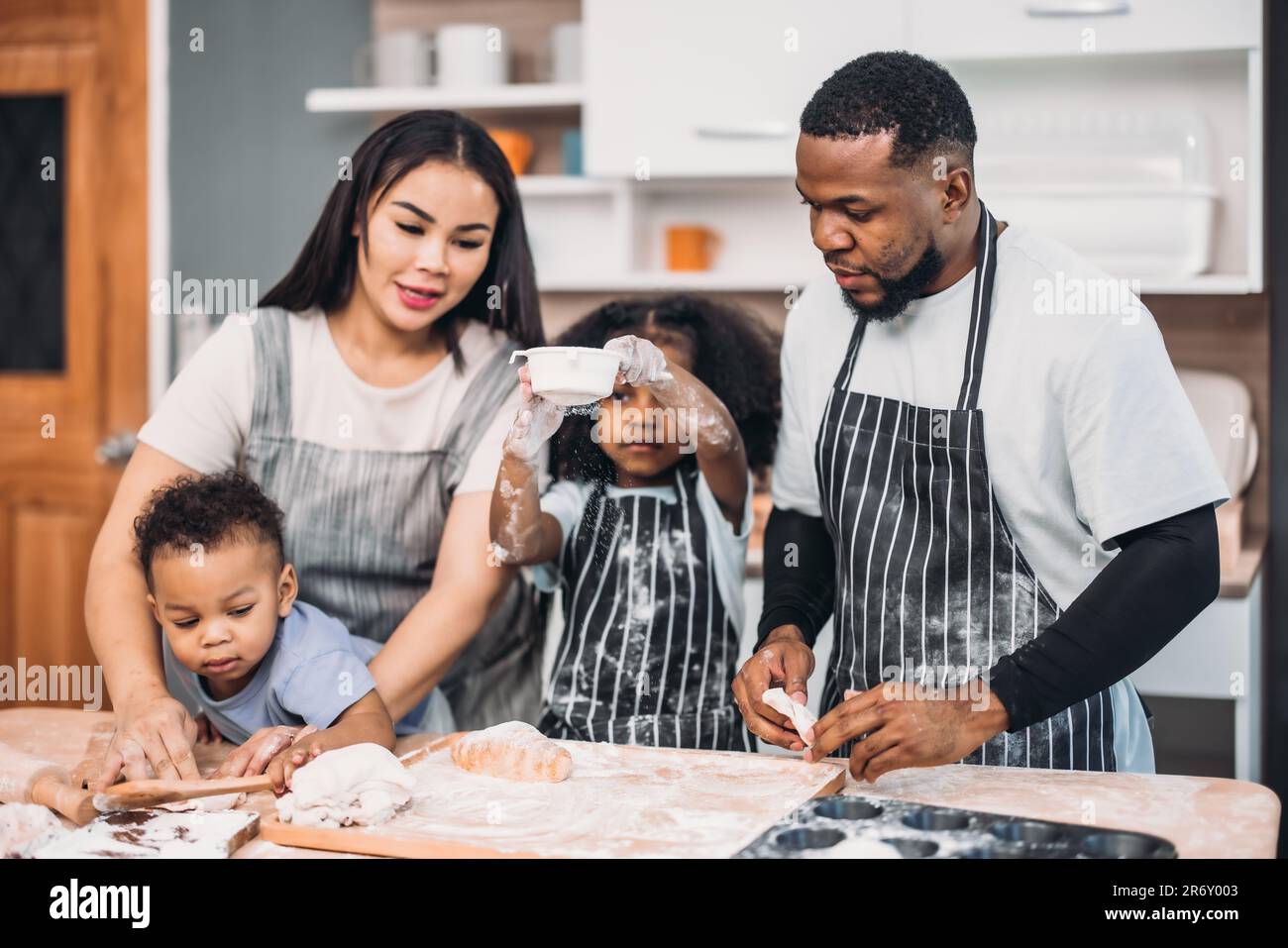Family members cook homemade pizza dough in funny and playful ways ...