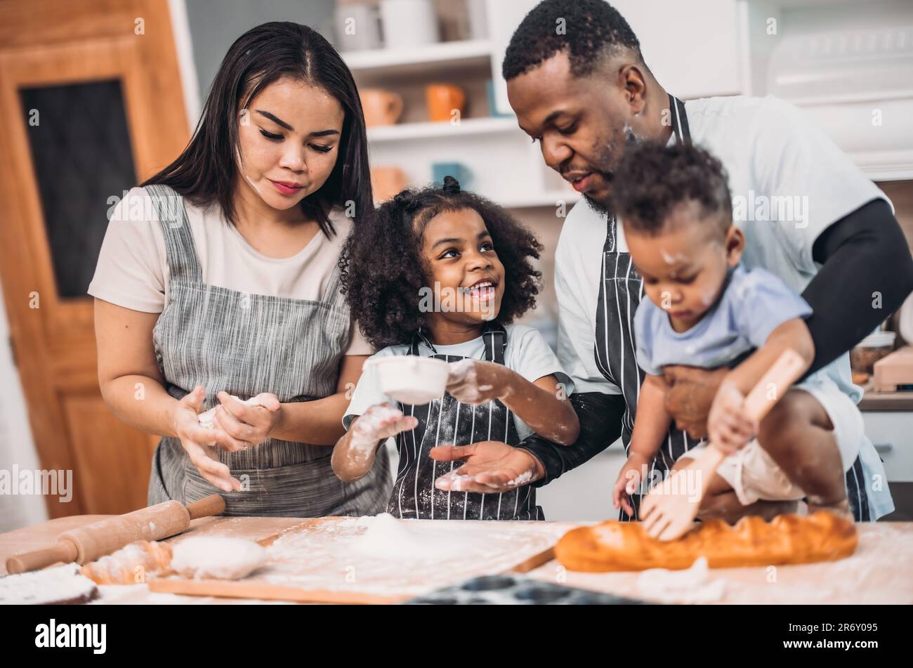 Family members cook homemade pizza dough in funny and playful ways ...