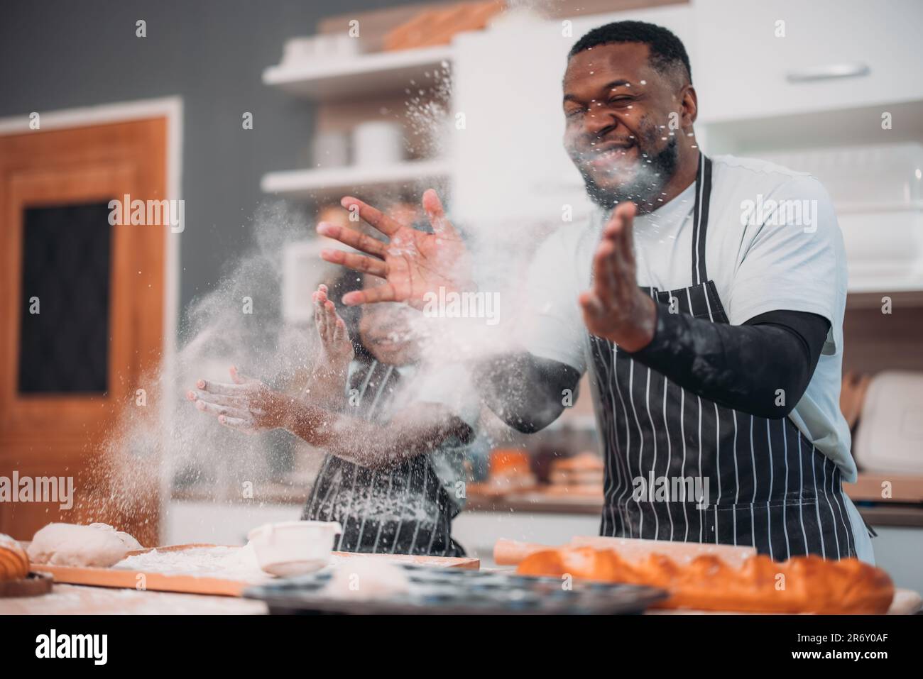 Family members cook homemade pizza dough in funny and playful ways ...