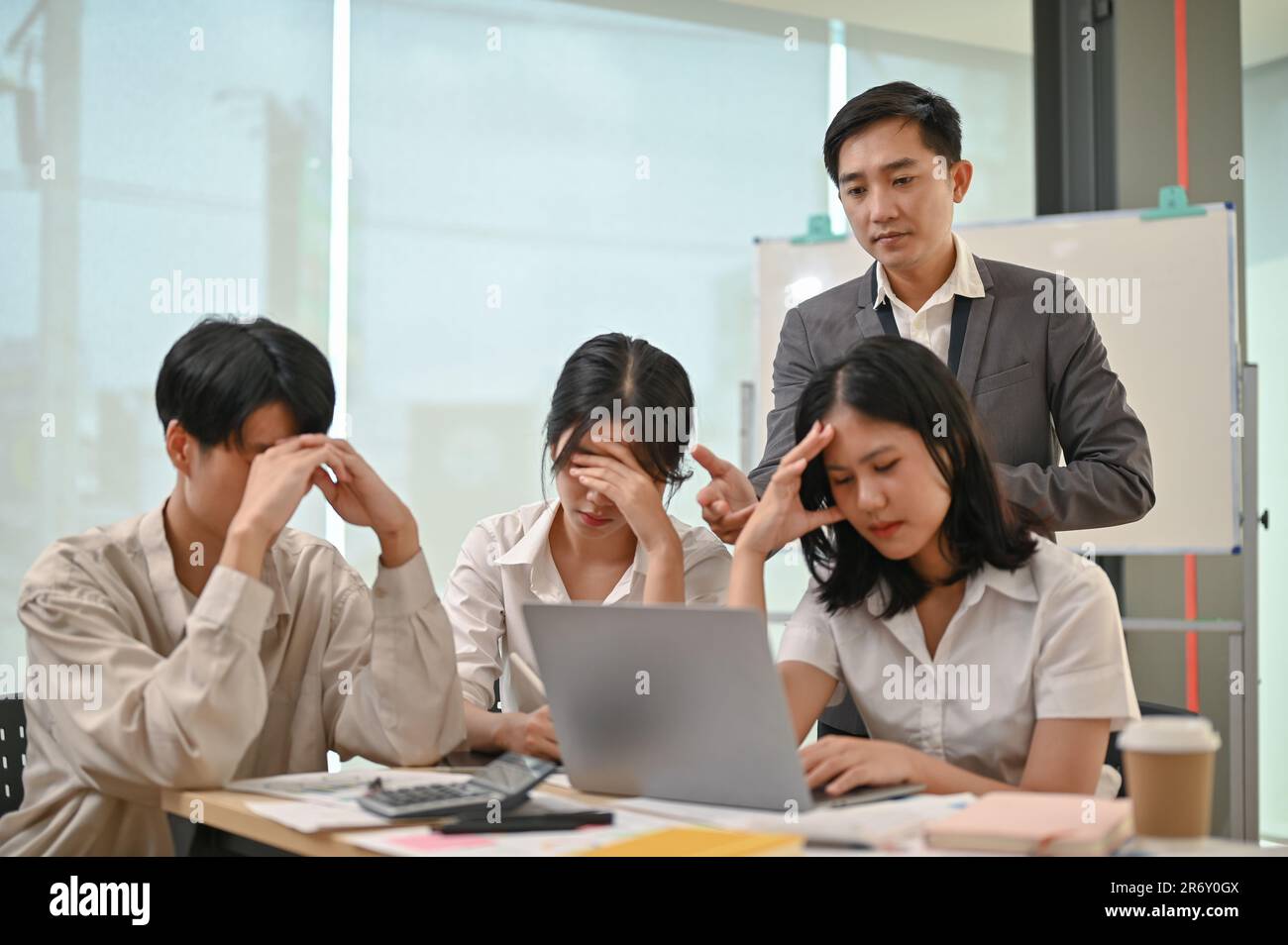 A serious and professional Asian male boss is complaining about the ...