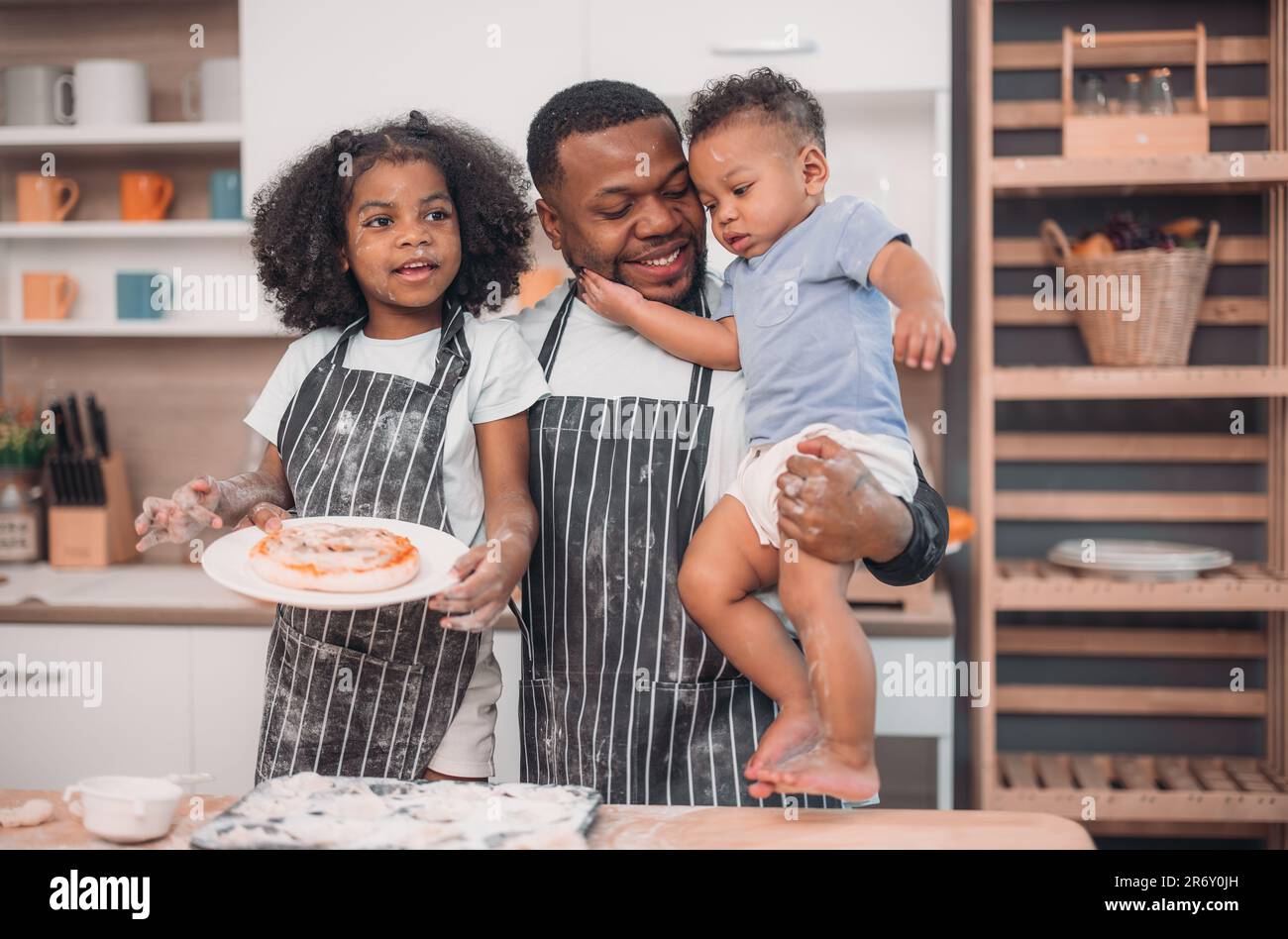 Family members cook homemade pizza dough in funny and playful ways ...