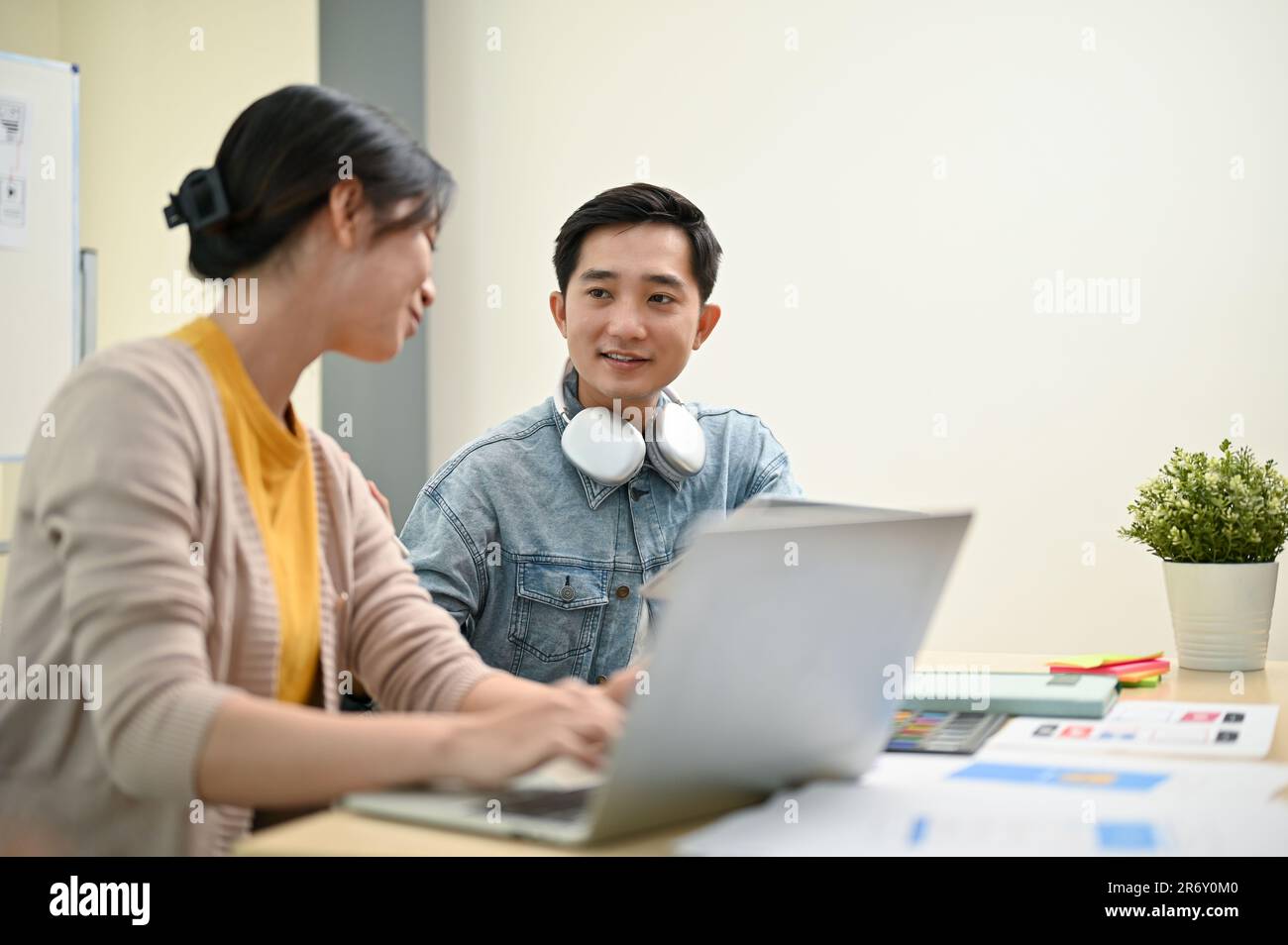 A smart and handsome millennial Asian male UX graphic designer is ...