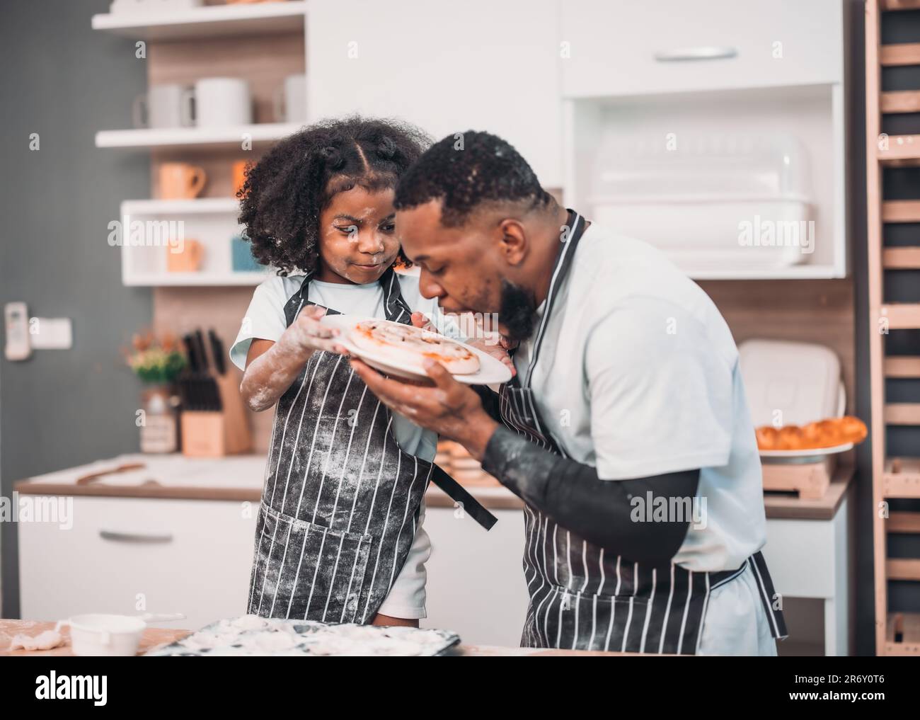 Family members cook homemade pizza dough in funny and playful ways ...