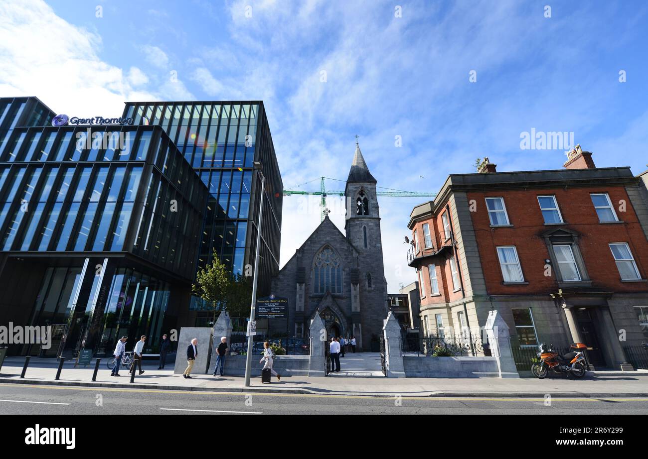 The Immaculate Heart of Mary Catholic Church next to the modern City ...