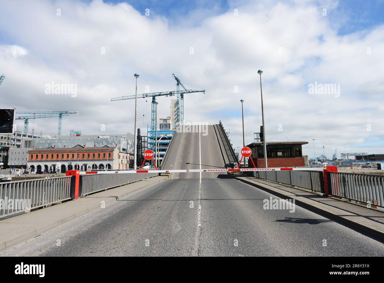 The Tom Clarke Bridge over Liffey River opening up for a ship. Dublin ...