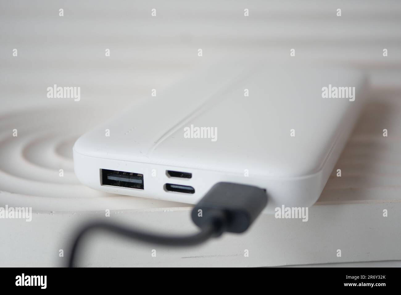 Power bank for charging mobile devices on table Stock Photo - Alamy