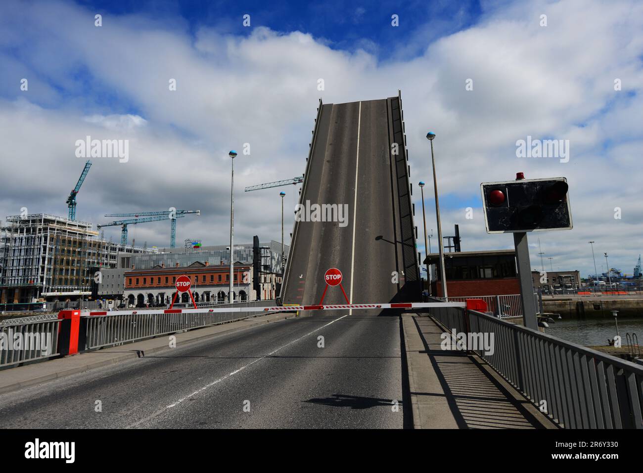 The Tom Clarke Bridge over Liffey River opening up for a ship. Dublin ...