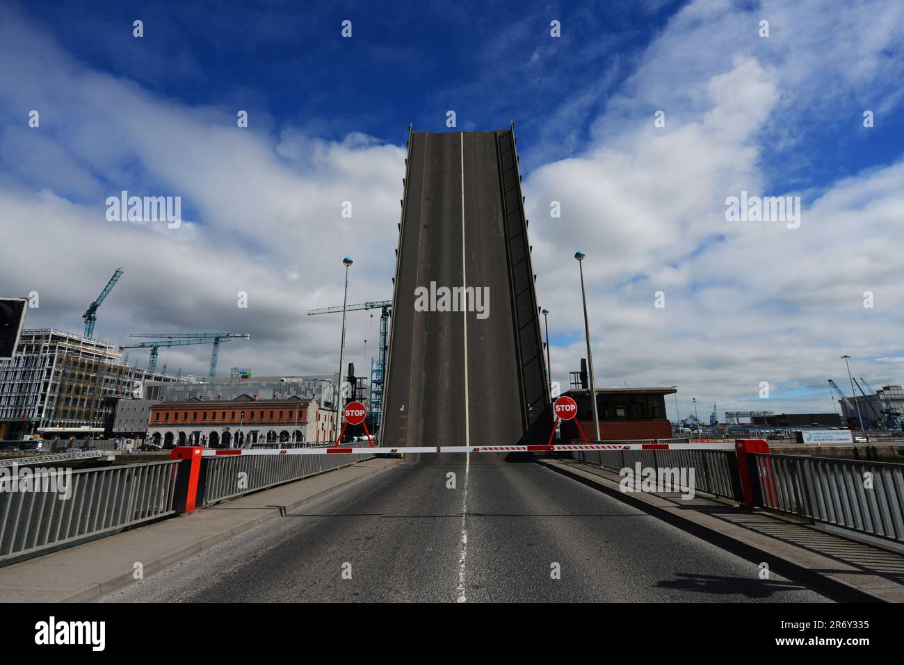 The Tom Clarke Bridge over Liffey River opening up for a ship. Dublin ...