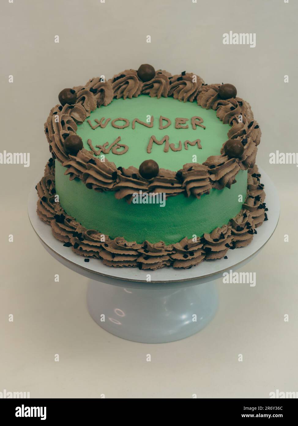 frosted icing elegnt cake with funny lettering topping. Mothers day ...