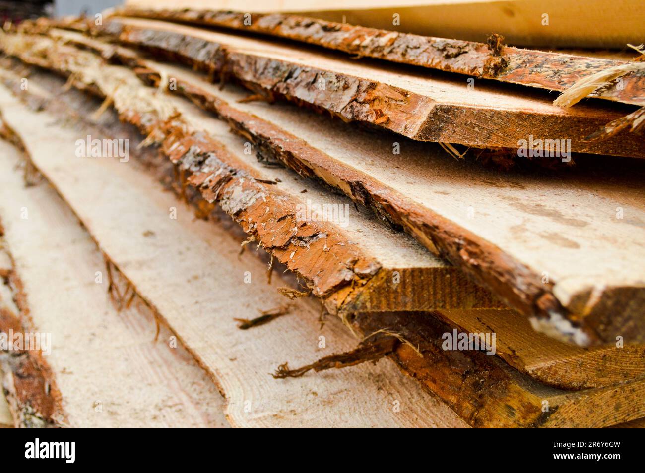 Lots of long wooden natural planed boards and sticks at a sawmill. The ...