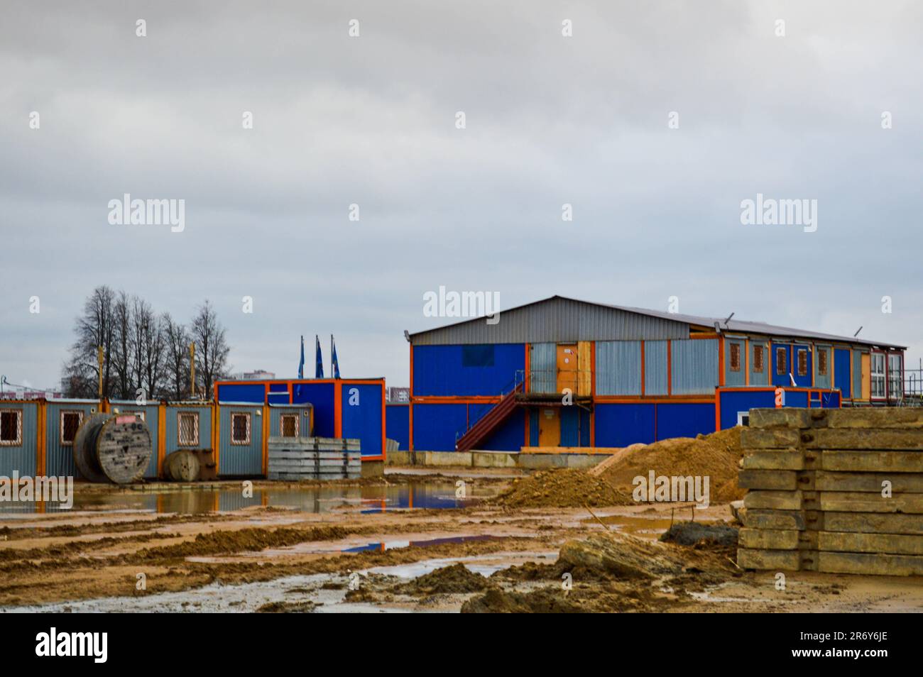 A large industrial barn warehouse and modular buildings for workers at ...