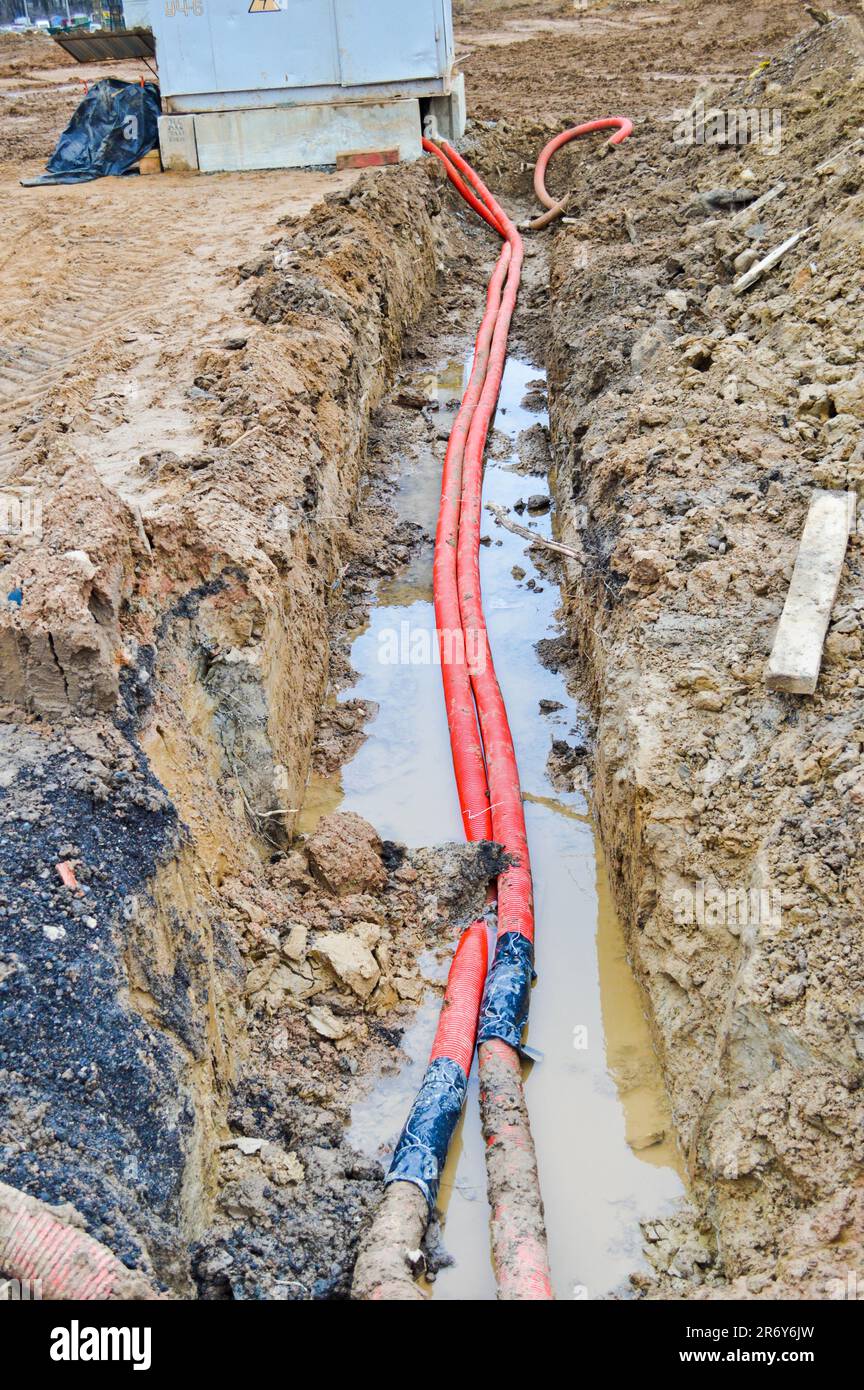 Large red plastic corrugated pipes with wires for a transformer ...