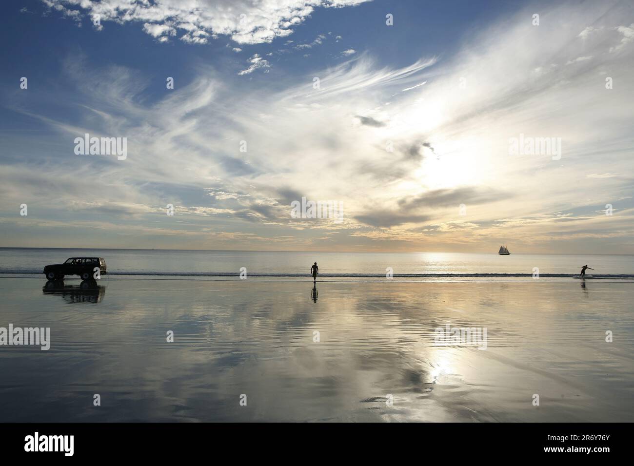 Boy enjoying car surfing at Broome Cable Beach Stock Photo - Alamy