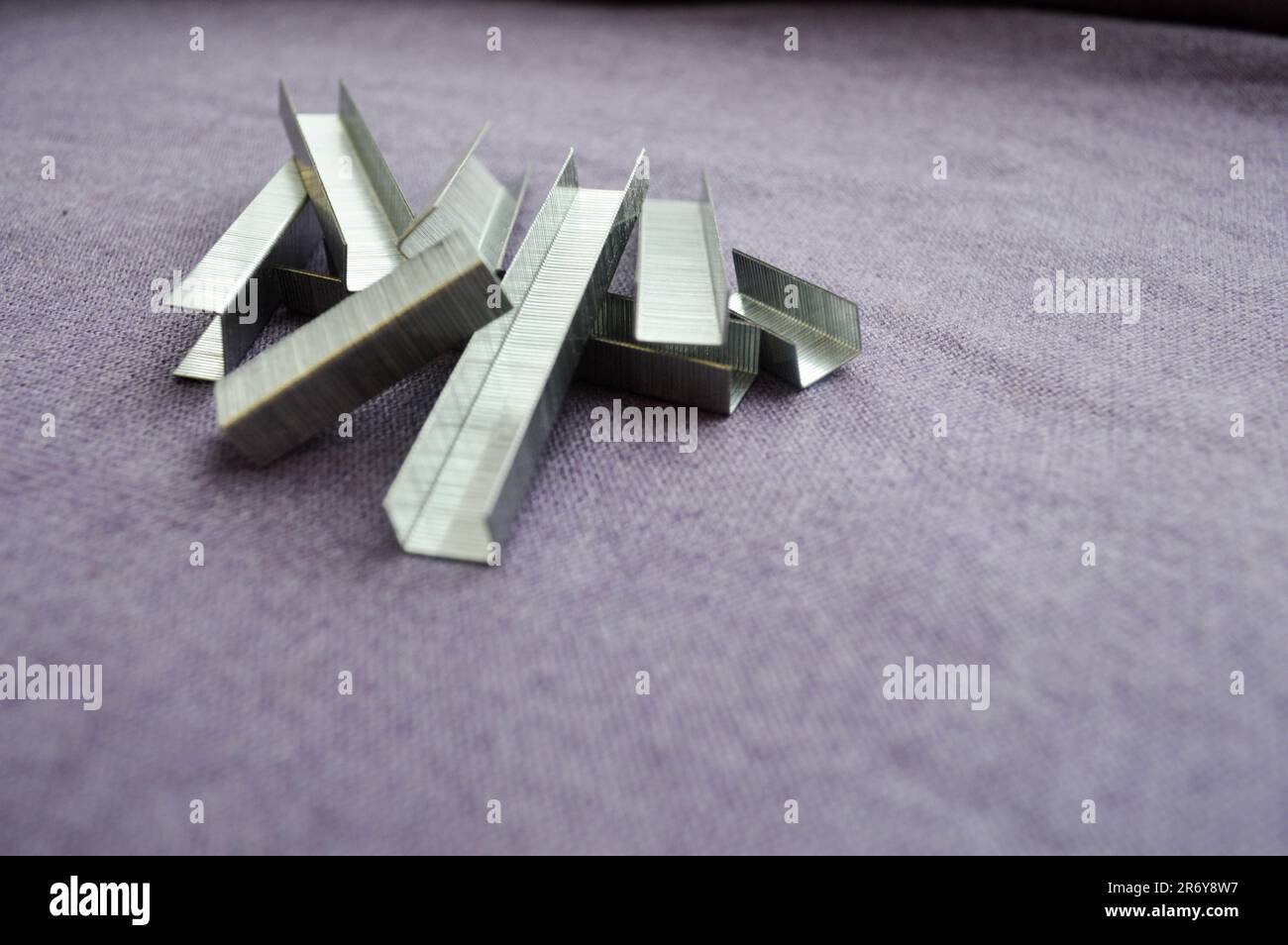 Iron, metal, silvery staples stacked in a heap against the background ...