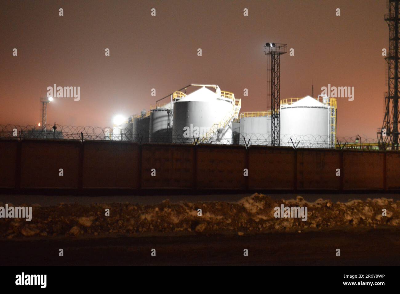 Night photo of a tank farm of a petroleum refinery, a petrochemical ...