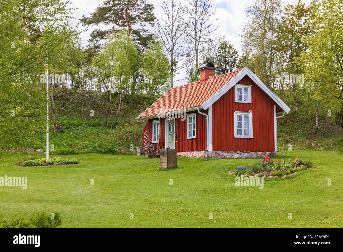 Red idyllic old cottage with a garden Stock Photo - Alamy