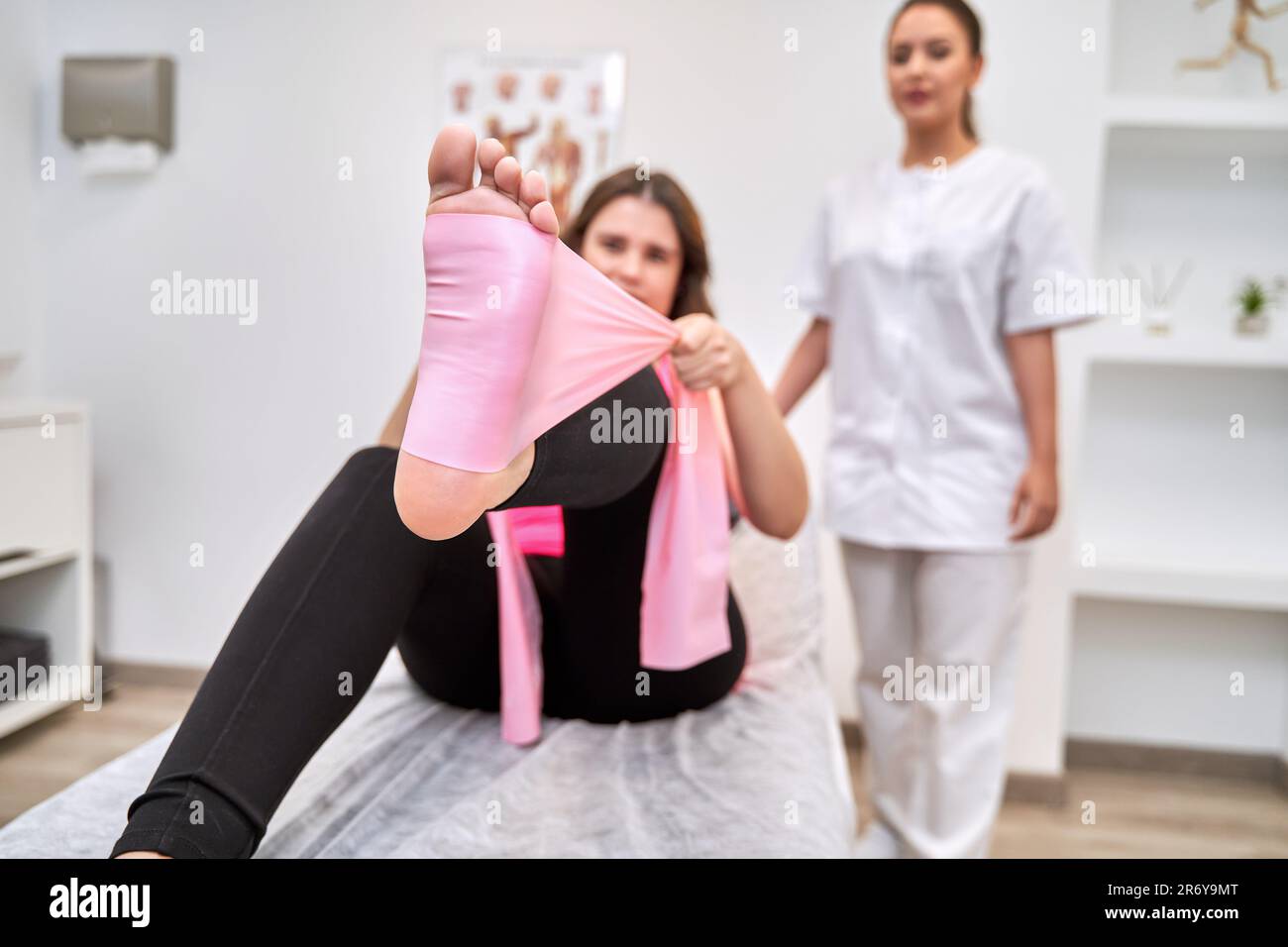 Experienced Physiotherapist Carefully Observes Female Patient ...