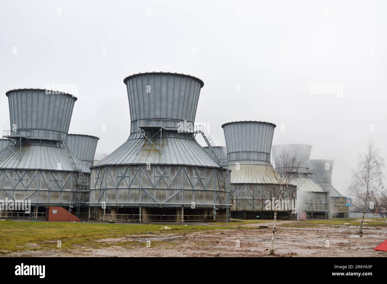 Large cooling towers in water and fog at an oil refinery, petrochemical ...
