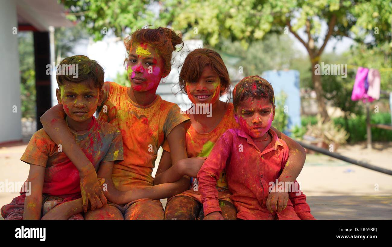 Portrait of Indian bright kids smeared in colored powder. Asian ...