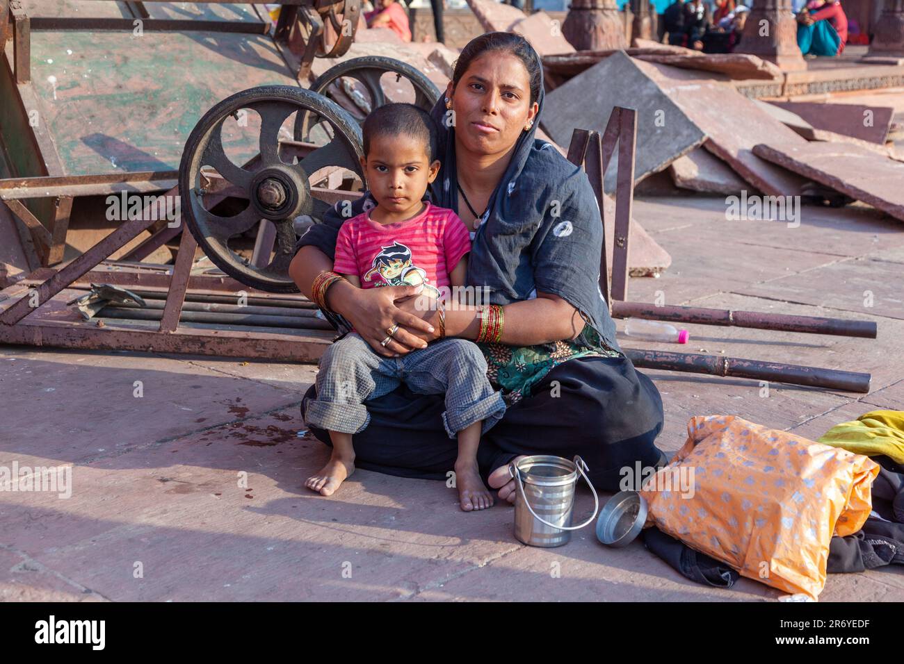 Delhi, India - November 10, 2011: mother with child rests on the ...