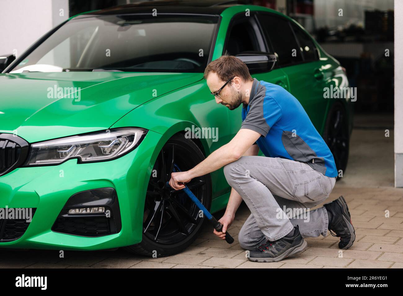 Mechanic checking tire service via insurance system at garage. Safety ...