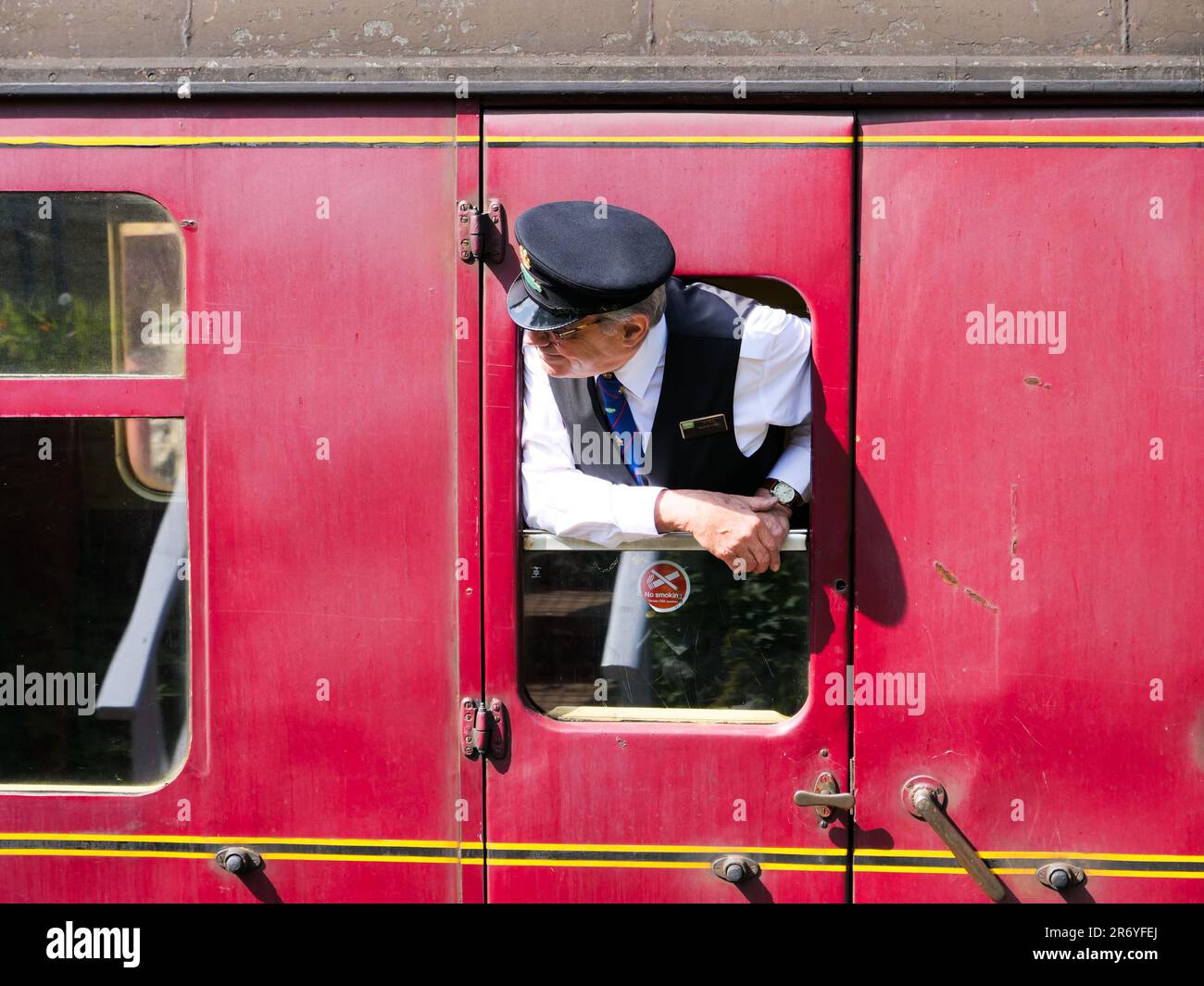 North York Moors Railway: A uniformed guard watches the arrival of ...