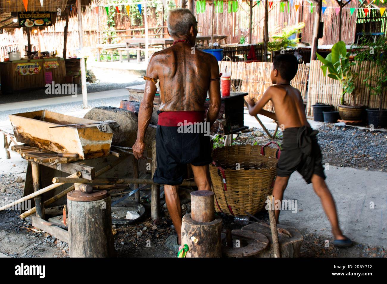 Thai oldman people blacksmith or metalsmith making ancient iron armor ...
