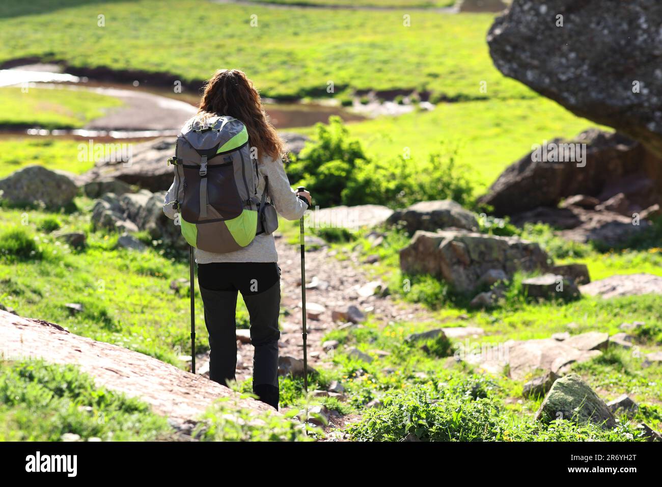 Back view portrait of a hiker woman walking in the mountain Stock Photo ...