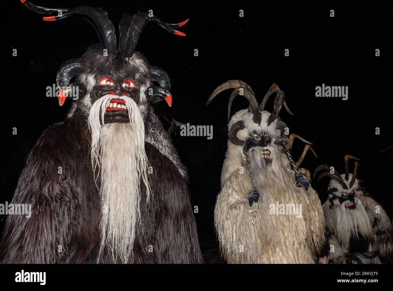 Three men in costumes of the legendary Christmas Krampus in animal ...