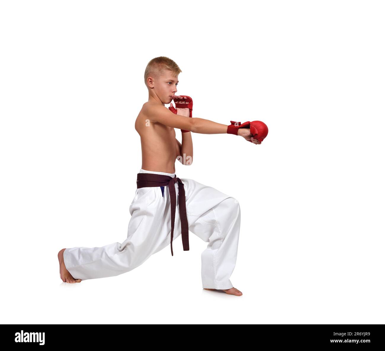 Boy making karate punch on white background Stock Photo - Alamy