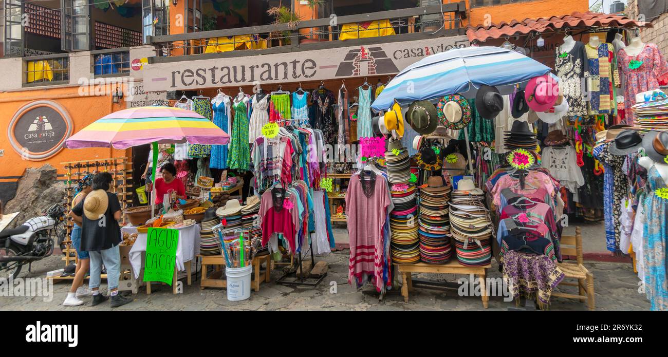 Street market stalls selling hats and clothing, Tepoztlán, State of ...