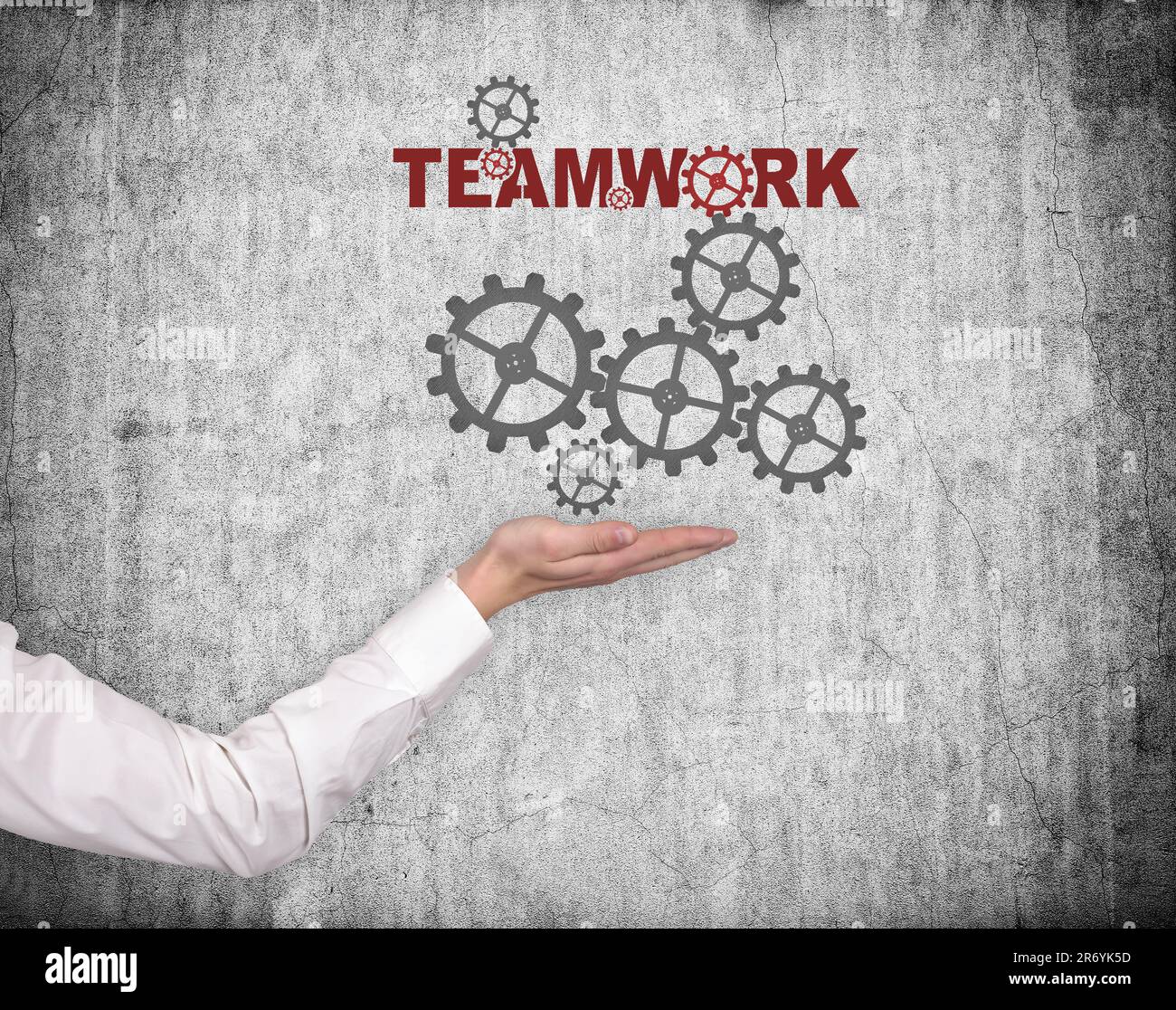 hand holding teamwork concept on gray wall background Stock Photo - Alamy