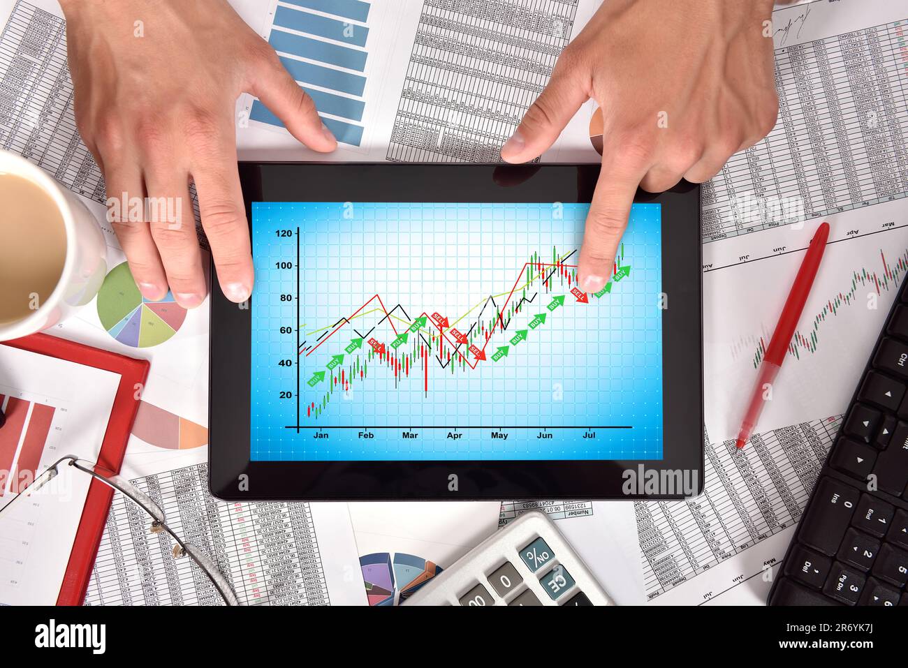 hands using touch pad with chart on screen Stock Photo - Alamy