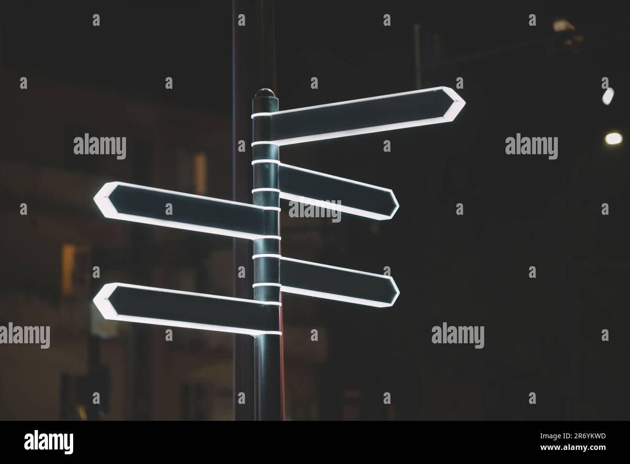 Street direction illuminated arrows at night Stock Photo - Alamy