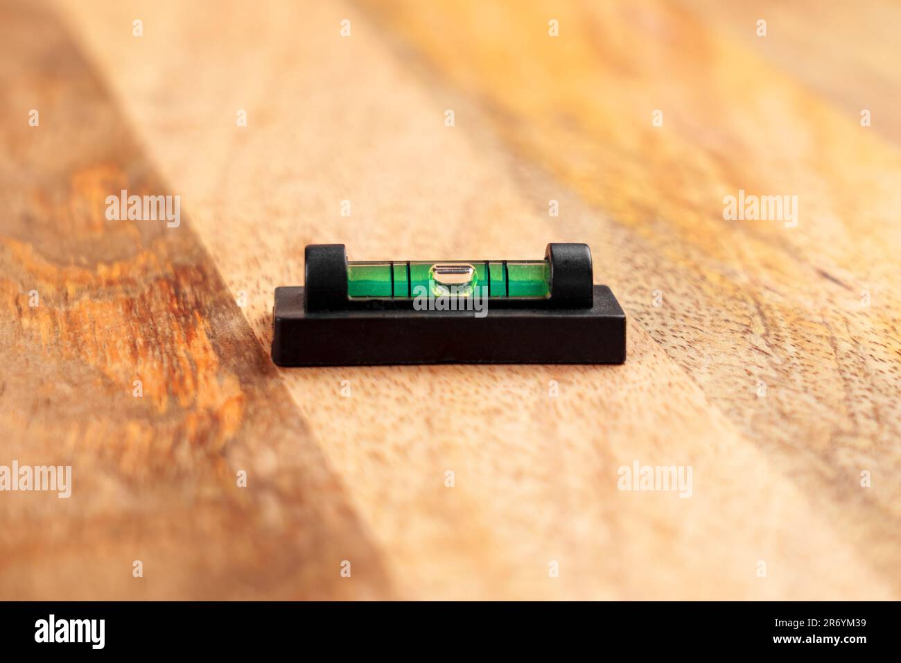 Small construction spirit level tool in work close up Stock Photo - Alamy