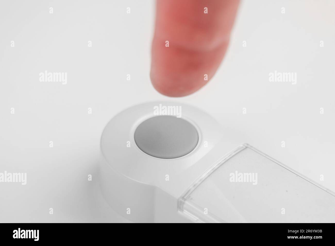 Patient hand pressing emergency nurse call button for help close up ...