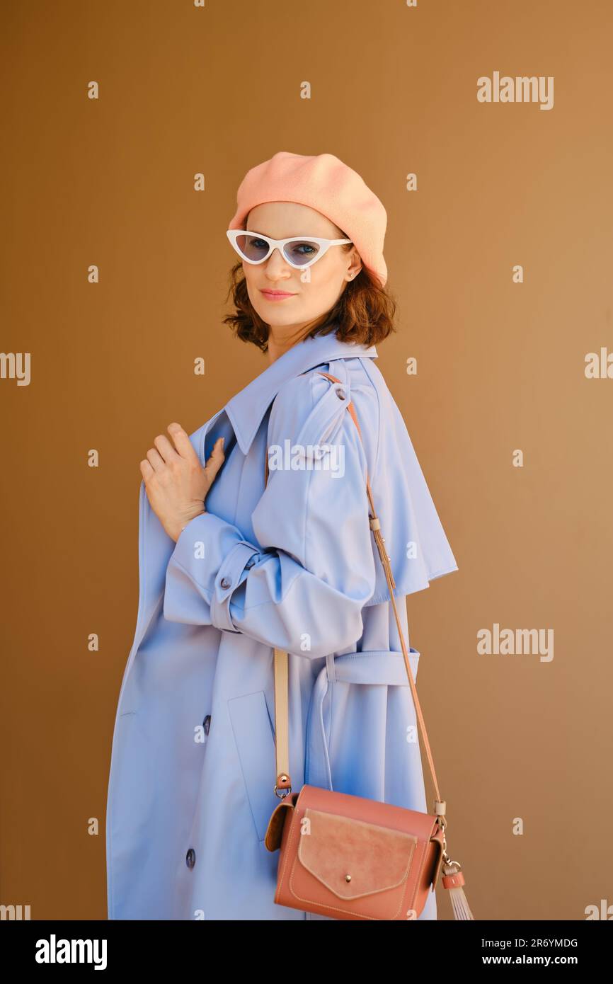 Pretty woman in blue coat, hat and sunglasses turned back Stock Photo ...