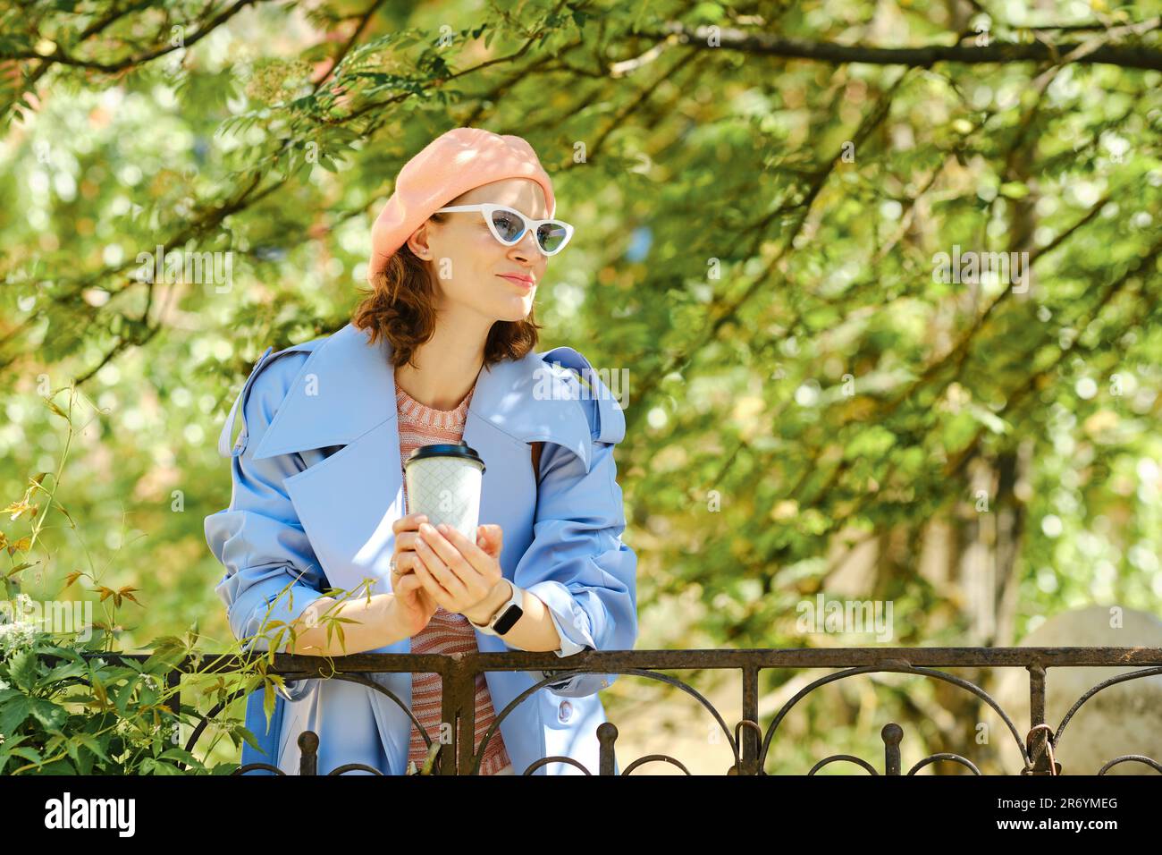 Woman leaning on railing hi-res stock photography and images - Alamy