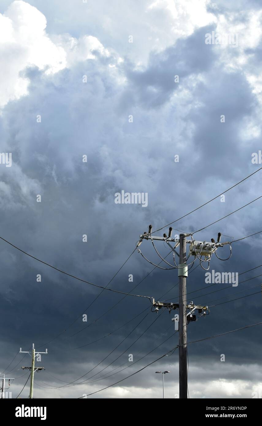 A vertical shot of a electricity pole carrying power through ...