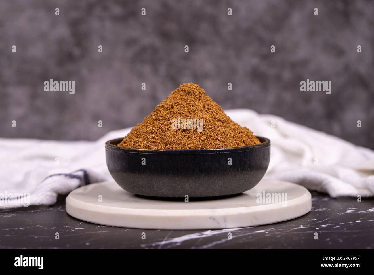 Coriander powder on dark background. Powdered dried coriander in bowl ...