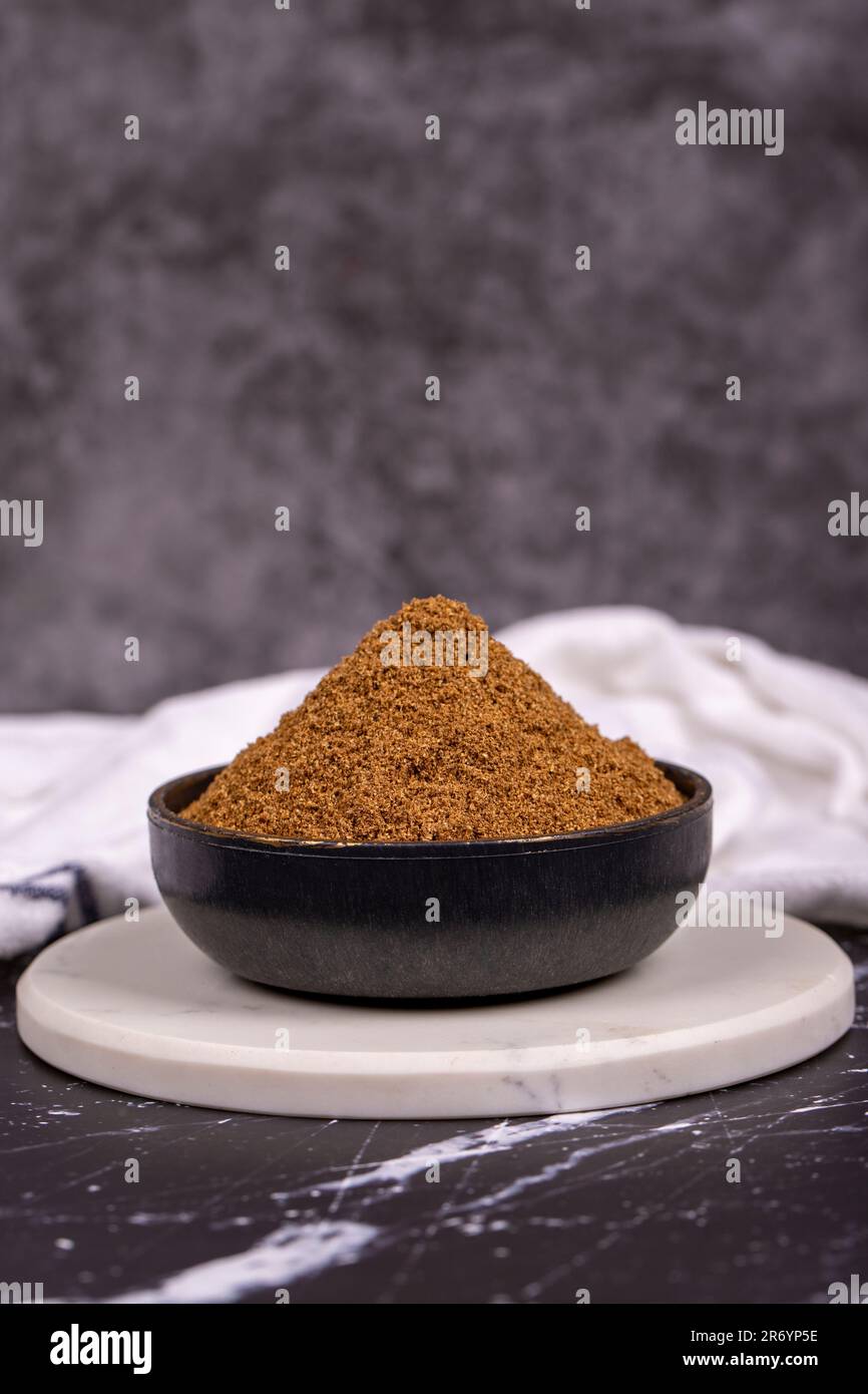 Coriander powder on dark background. Powdered dried coriander in bowl ...