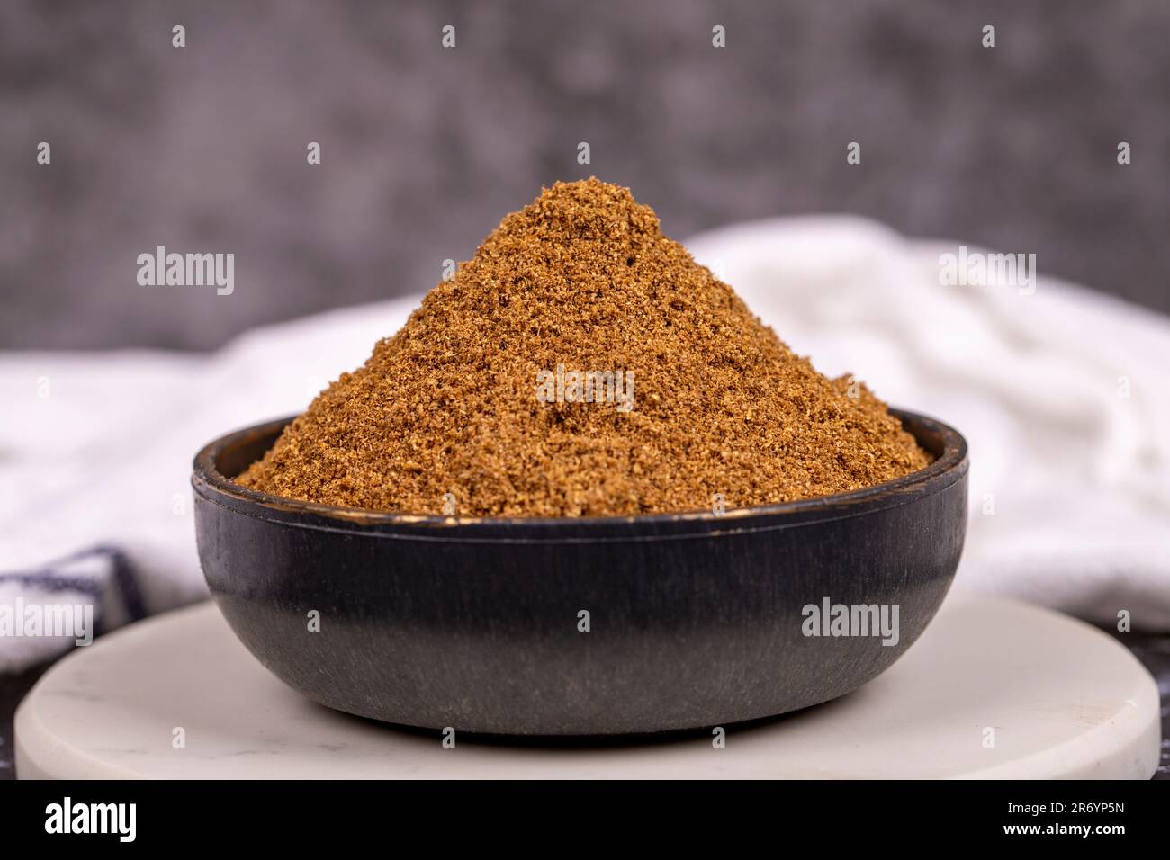 Coriander powder on dark background. Powdered dried coriander in bowl ...