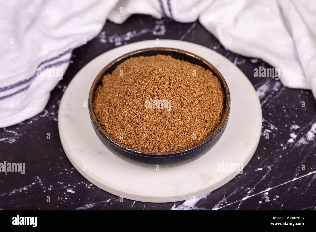 Coriander powder on dark background. Powdered dried coriander in bowl ...